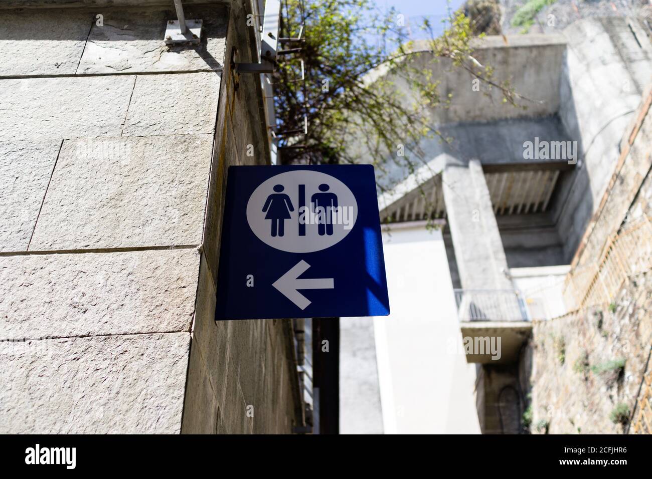 Low angle shot of a restroom sign on a wall under the sunlight with a ...