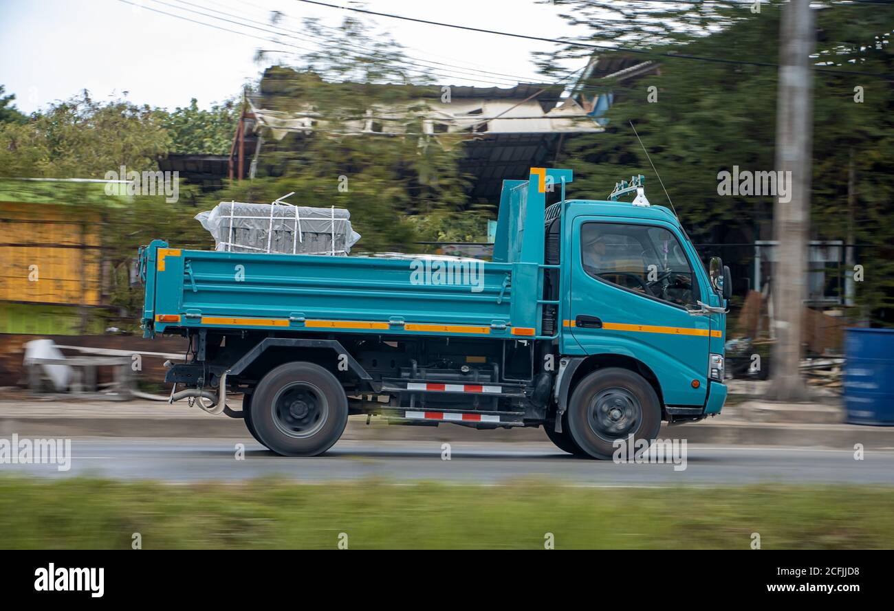 A lorry with freight ride on a city street with blurred surrounding ...