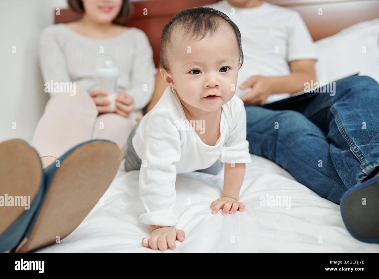Girl crawling on bed Stock Photo - Alamy