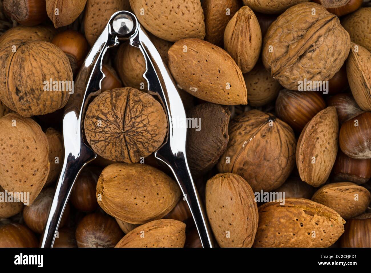nutcrackeron pile of nuts background Stock Photo - Alamy