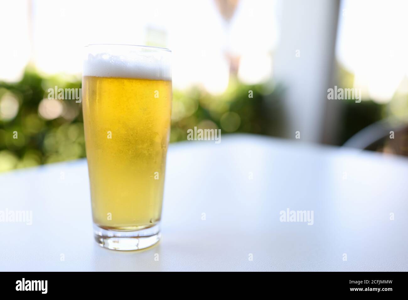 Glass alcoholic beer is on table in bar Stock Photo - Alamy