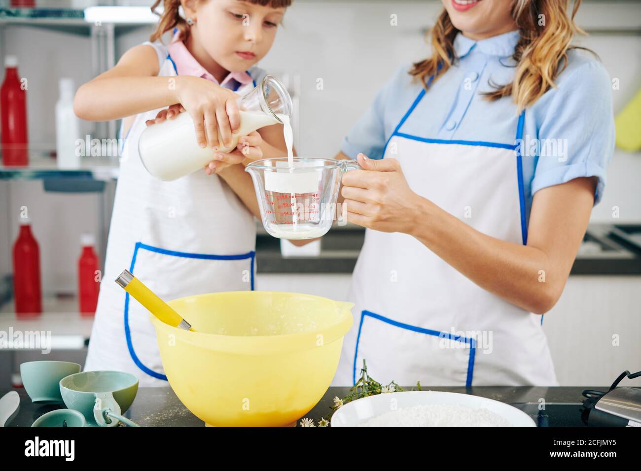 Adding milk in dough Stock Photo - Alamy