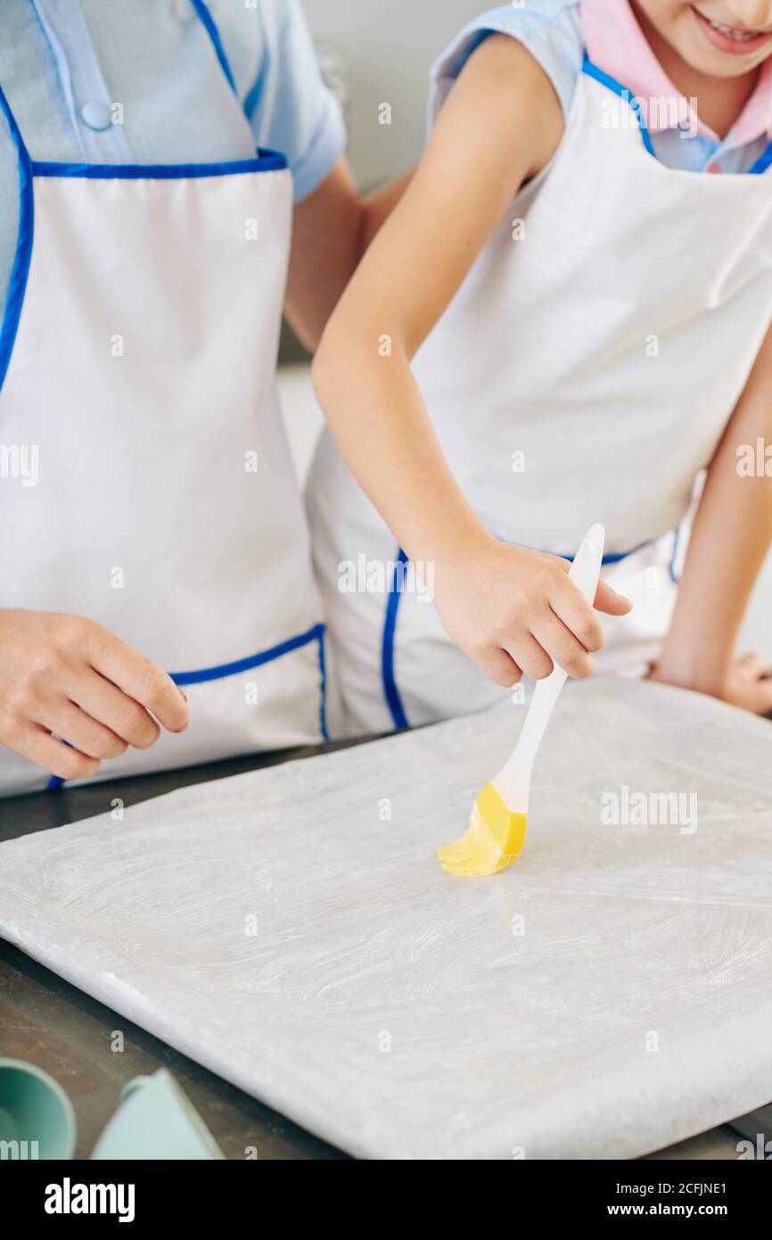 Girl baking with mother Stock Photo - Alamy