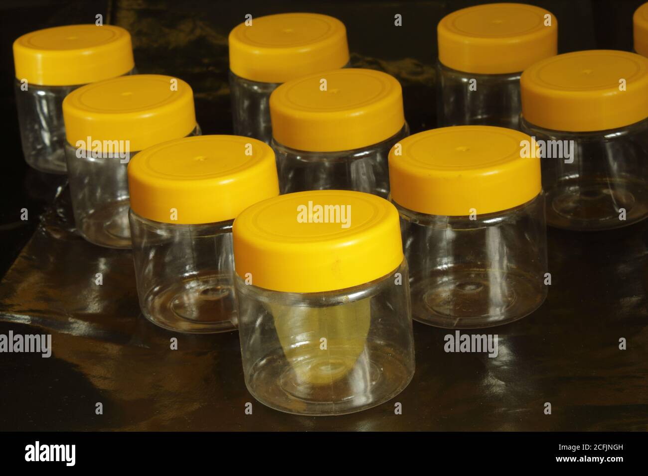 Empty jars ready for filling on a black background Stock Photo - Alamy