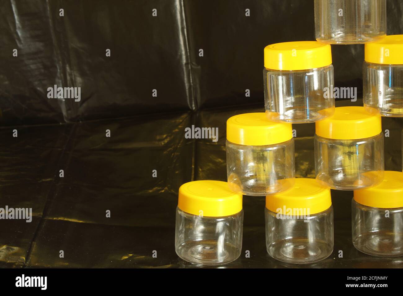 Empty jars ready for filling on a black background Stock Photo - Alamy