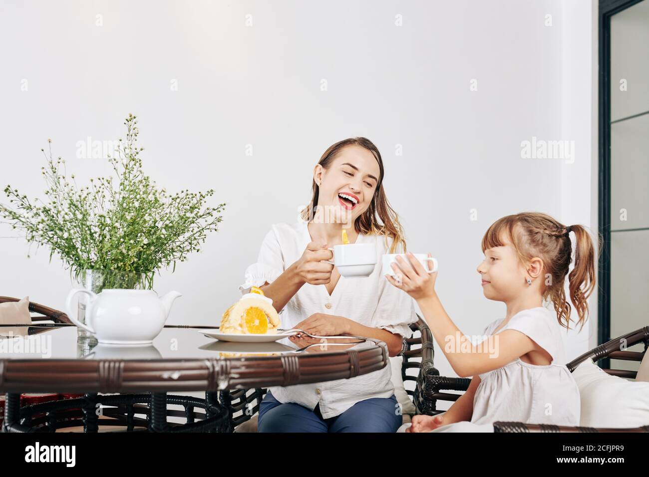 Mother and daughter drinking tea Stock Photo - Alamy