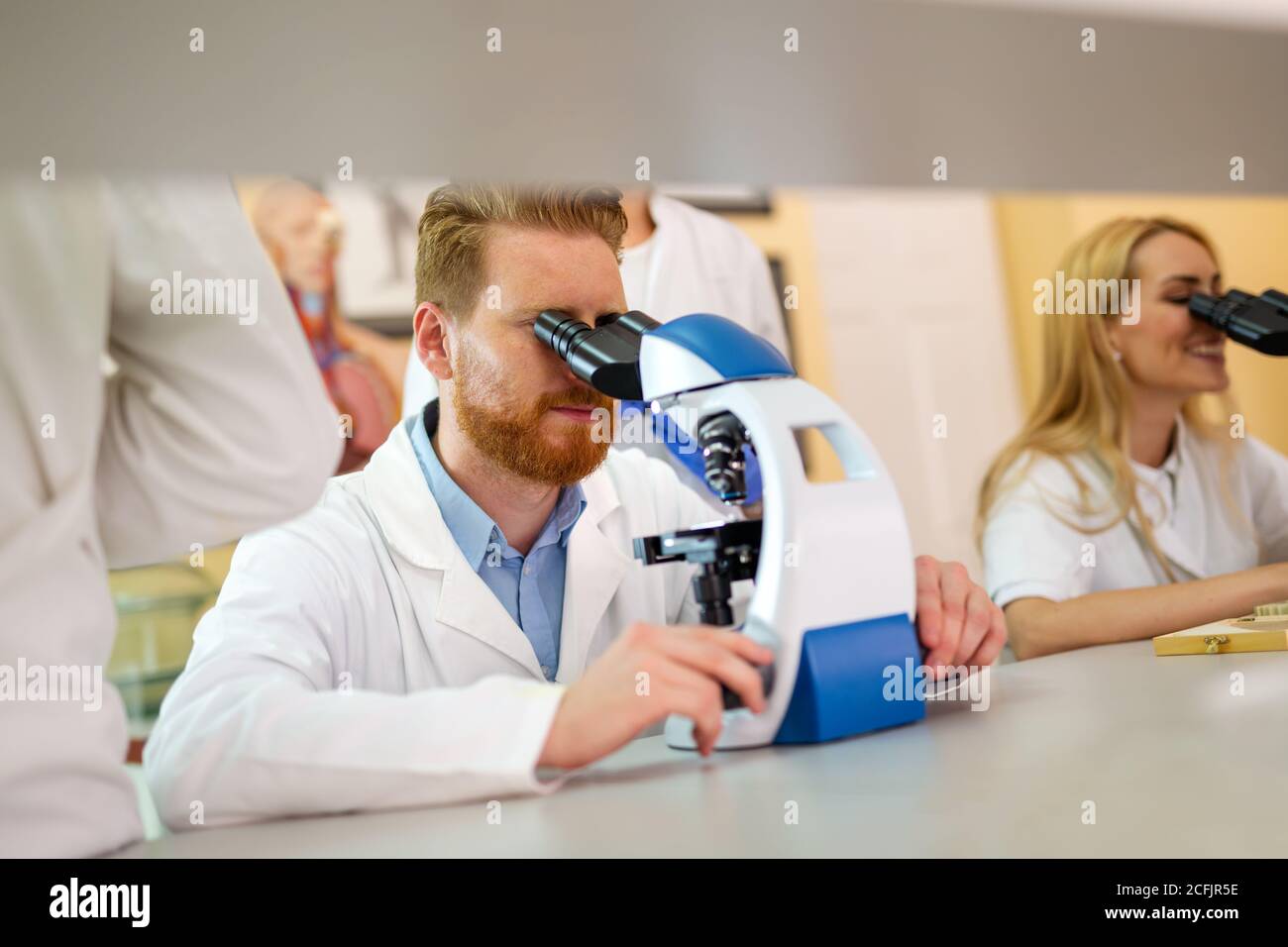 Scientists working microscope test hi-res stock photography and images ...