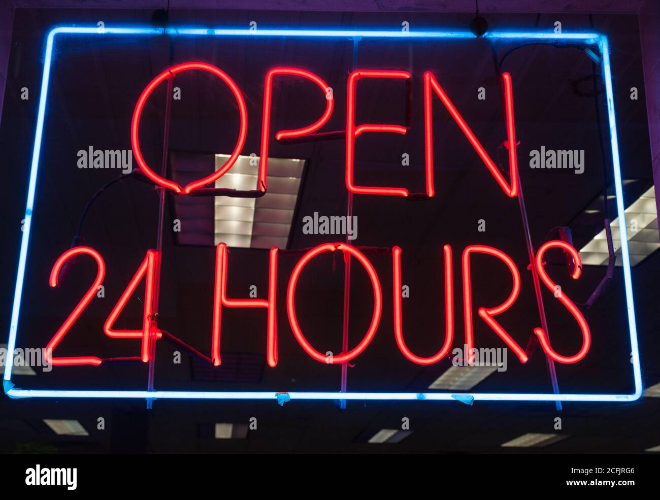 open 24 hours neon sign in a store window Stock Photo - Alamy