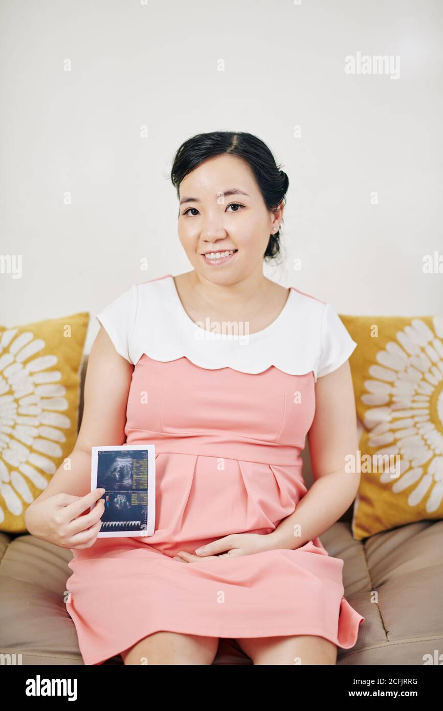 Pregnant woman showing ultrasound scan Stock Photo - Alamy