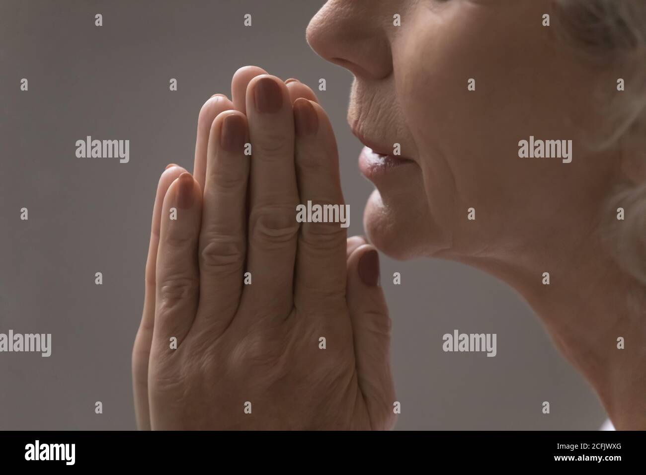Close up religious faithful mature woman praying with hope Stock Photo ...