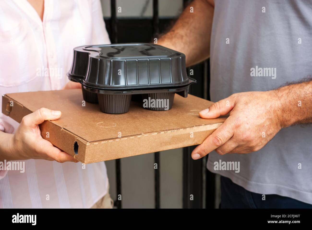 Food delivery service man with pizza cardboard and take away coffee ...