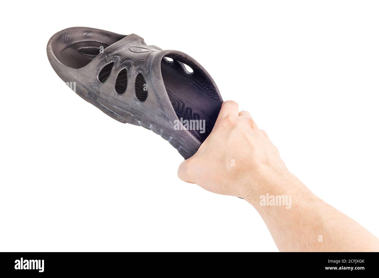 caucasian hand holding black rubber slipper like weapon against ...