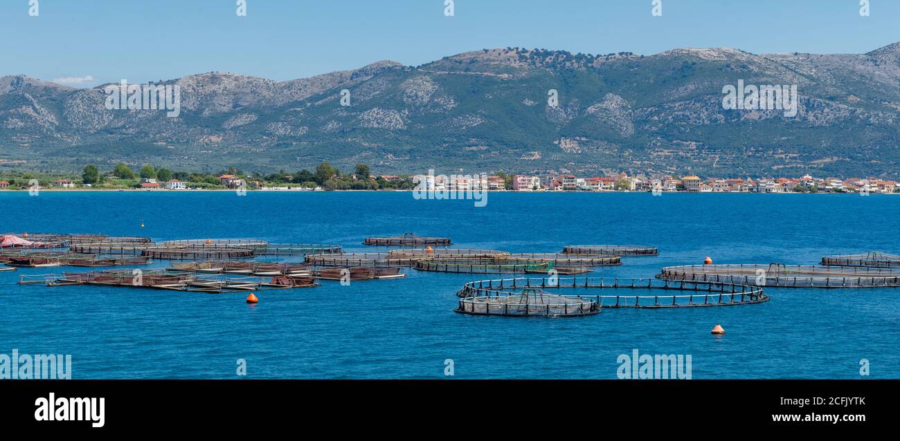 The seaside town Mytikas with a mountain backdrop and beautiful blue ...