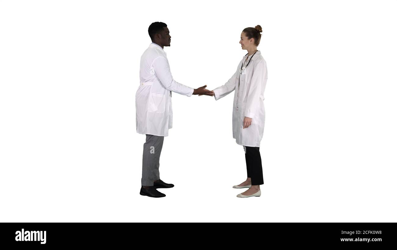 Successful team of surgeons giving high five and laughing isolated on ...