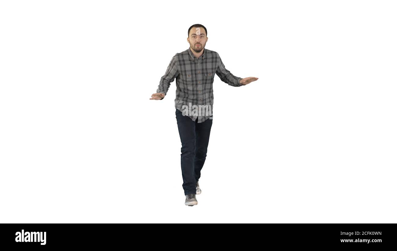 Young man in a casual outfit walking and dancing on white background ...