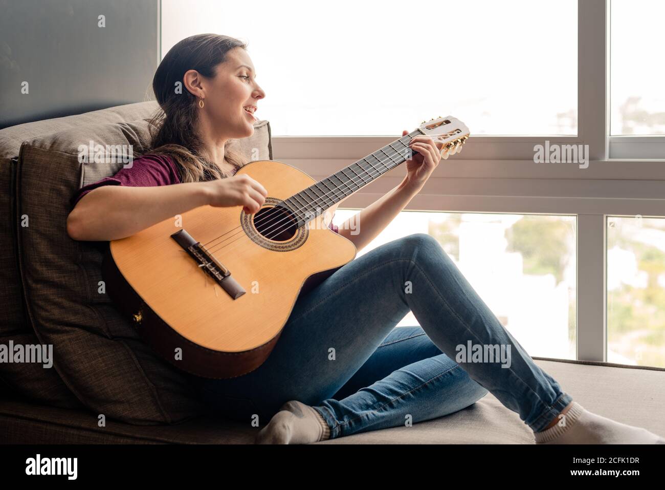 Young caucasian woman playing guitar hi-res stock photography and ...