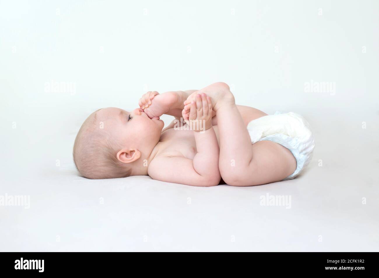 Cute adorable baby girl lying on the bed Stock Photo - Alamy
