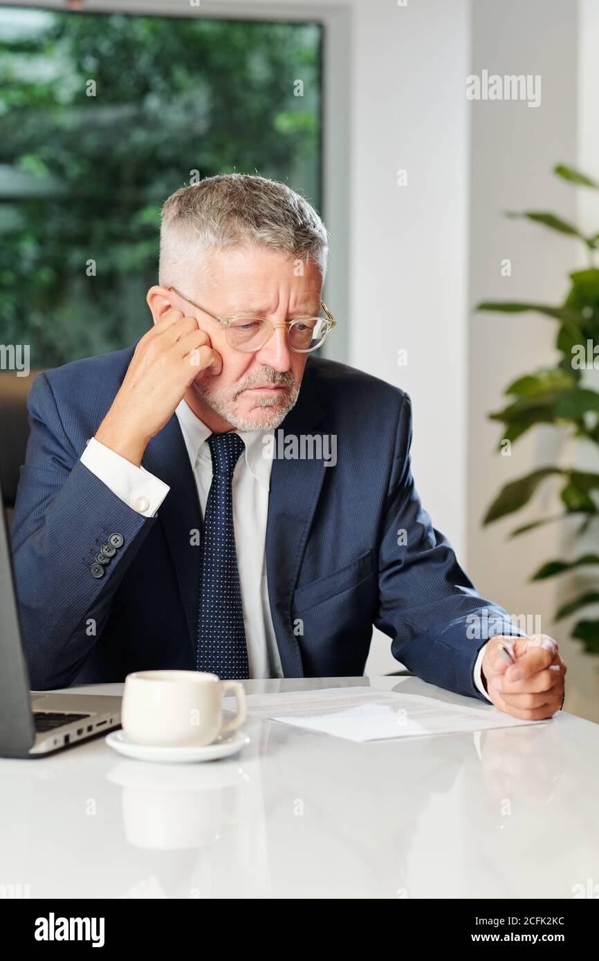 Entrepreneur reading business document Stock Photo - Alamy