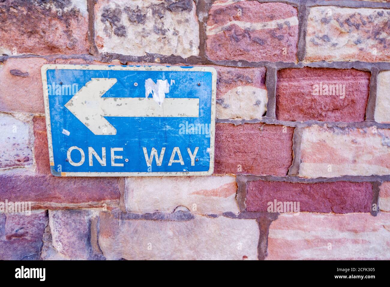 Brick Wall with Blue and White One Way Sign Stock Photo - Alamy
