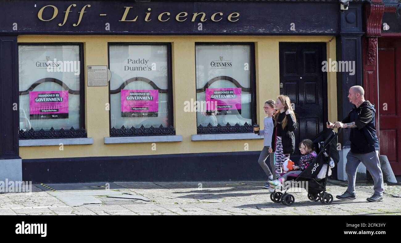 PARENTAL PERMISSION GIVEN People walk past Paddy Dunne's, a pub in Athy ...