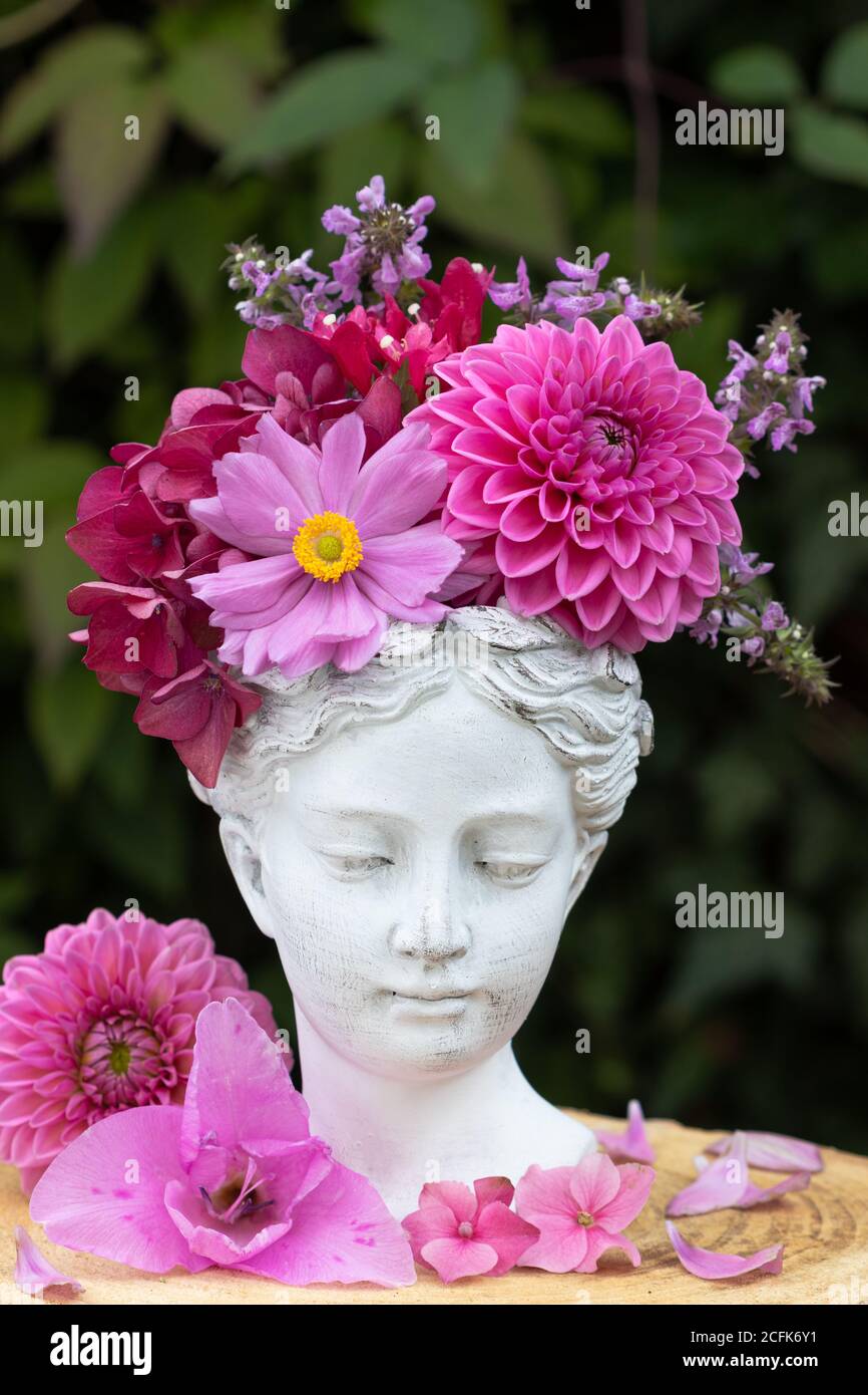 romantic garden decoration with woman bust and pink flowers Stock Photo ...