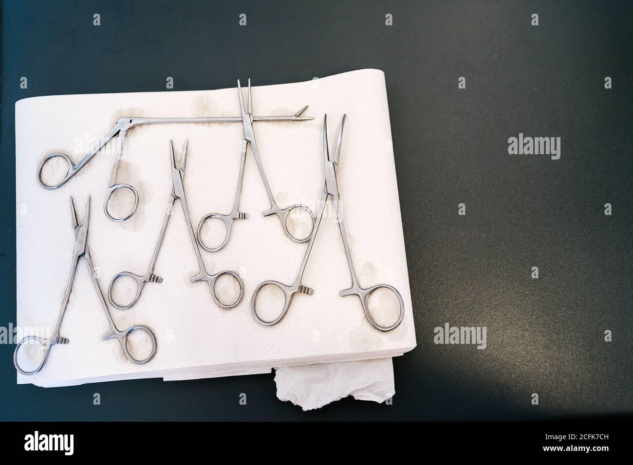 Top view of collection of clean surgical scissors placed on paper ...