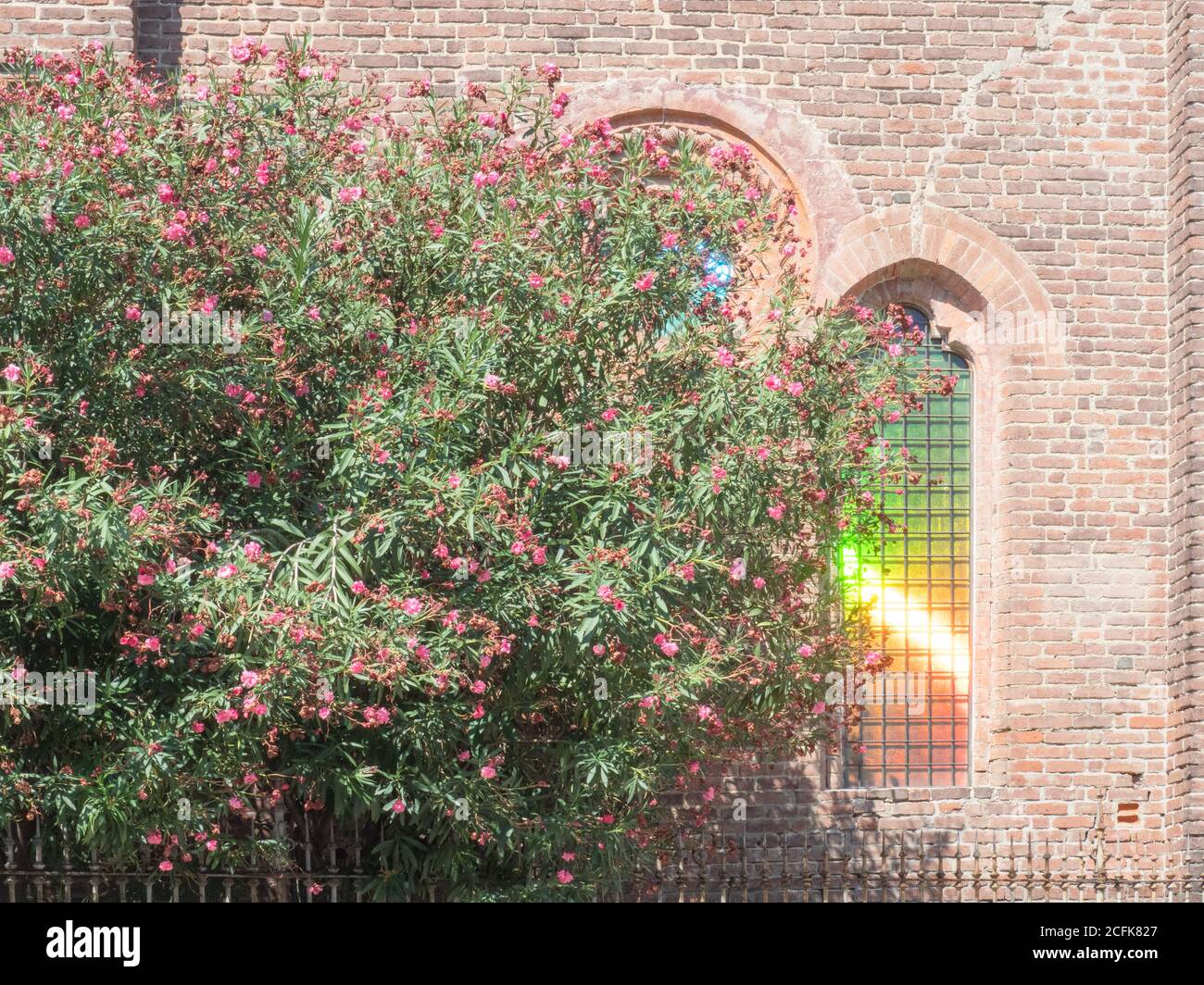 glare caused by sunlight on the stained glass windows of a brick church ...
