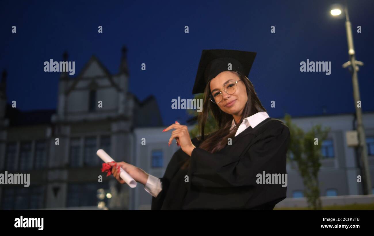 Medium shot. Slow motion.Education, graduation concept. Graduate girl ...