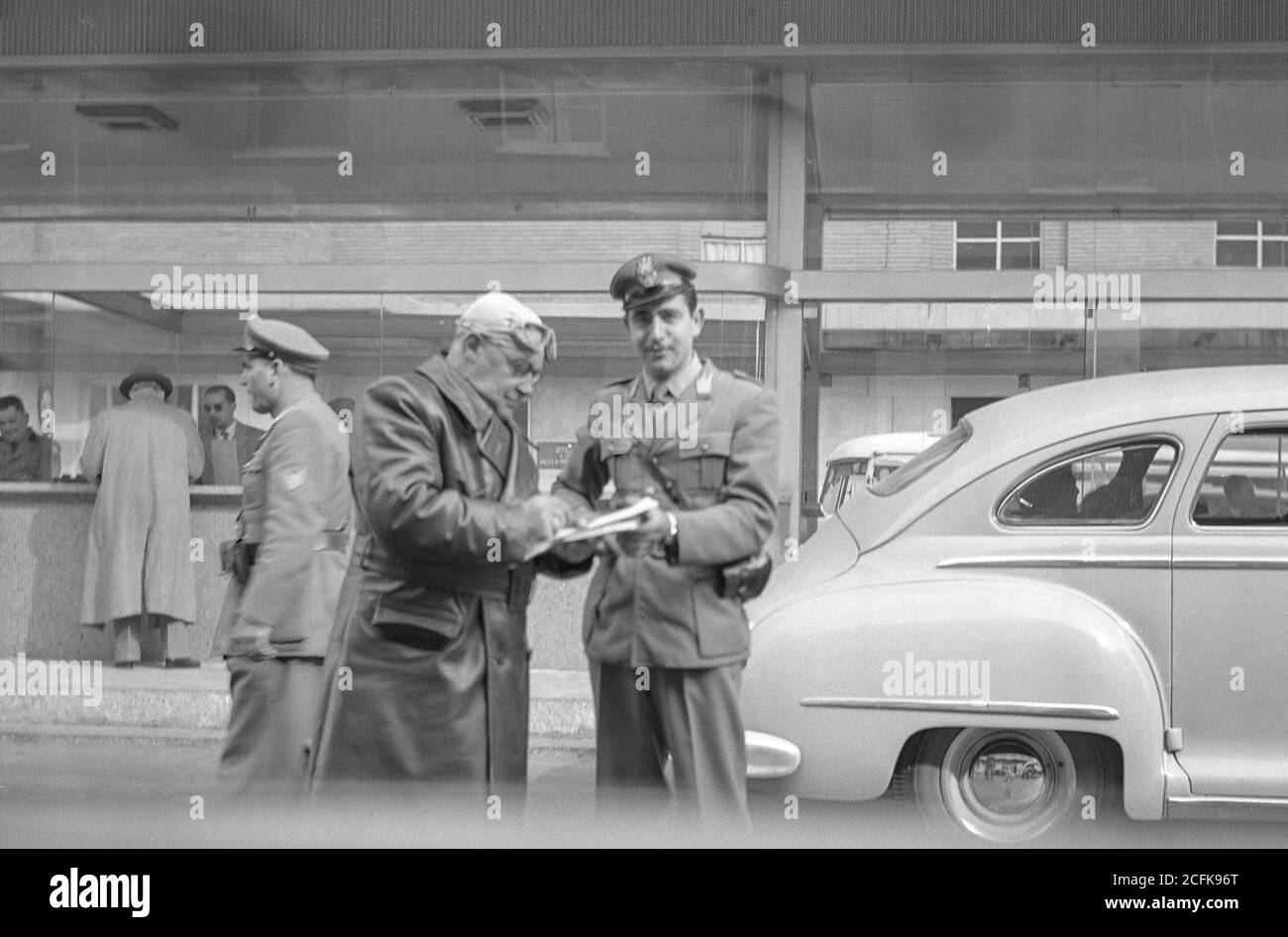Italian customs official checking papers at the border crossing from ...