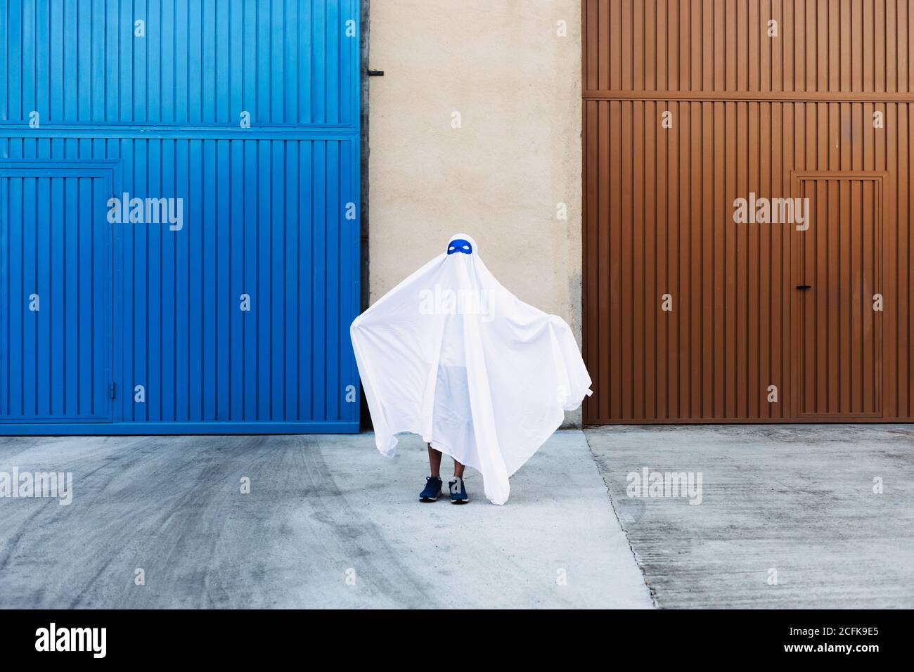 faceless child in white ghost costume frightening with outstretched ...