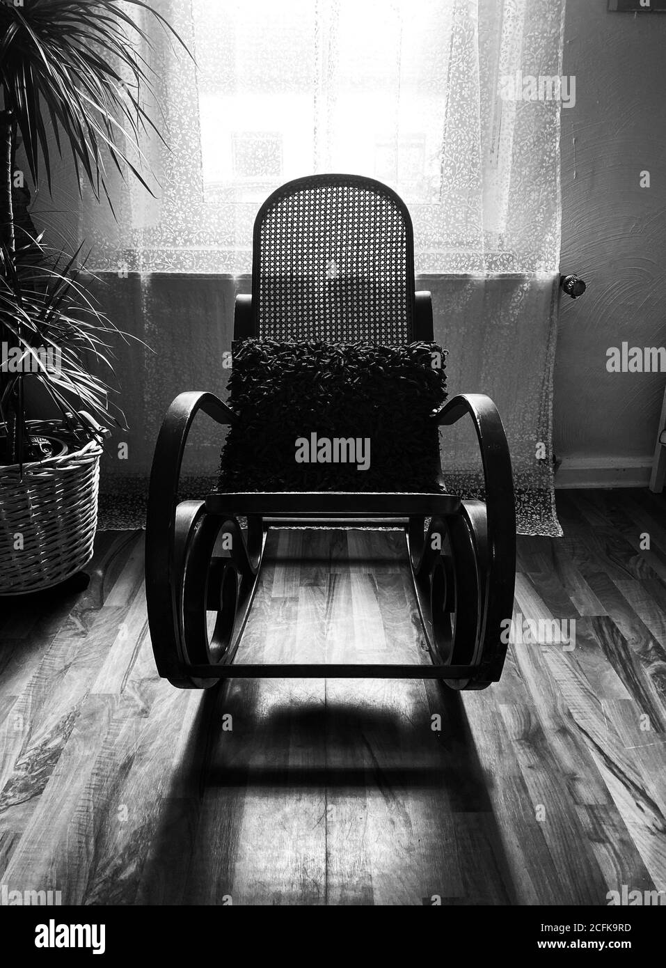 View on empty rocking chair in living room with shadow from backlight ...