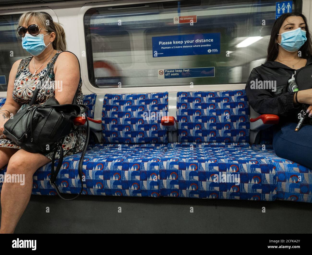 Passengers on the London Underground train carriage wearing face ...