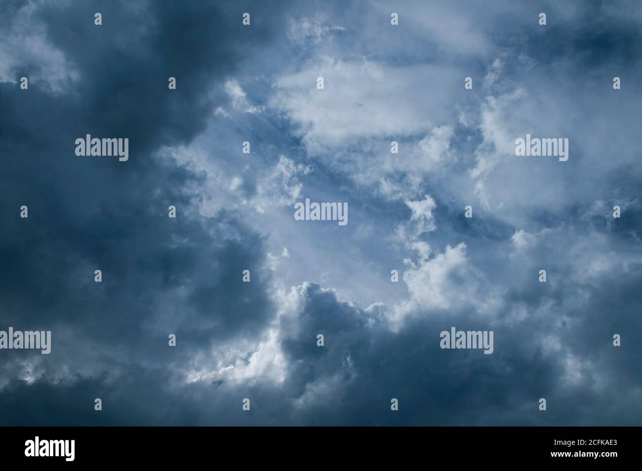 Dramatic dark blue sky with heavy clouds background Stock Photo - Alamy