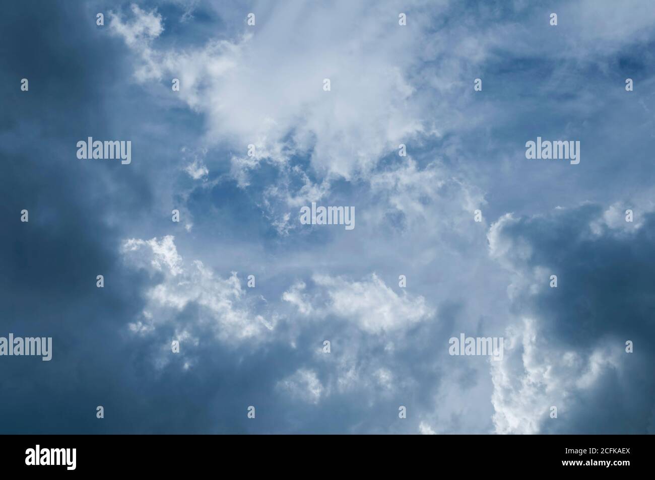 Dramatic dark blue sky with heavy clouds background Stock Photo - Alamy