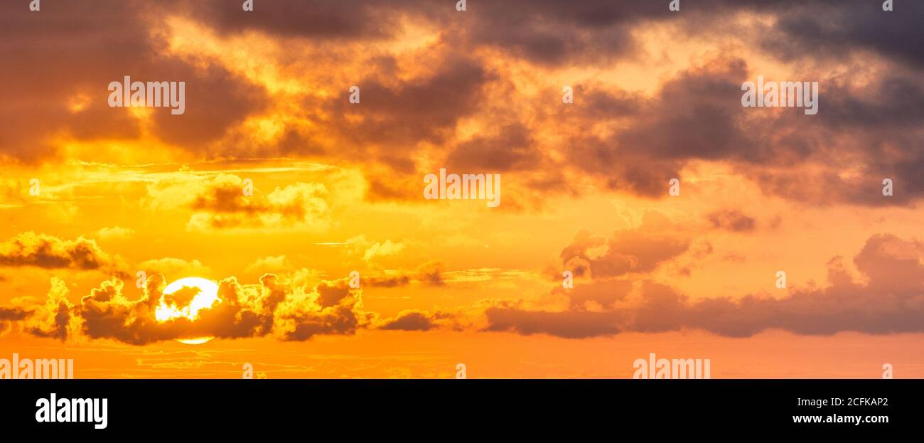 Amazing sunset on a tropical island, detail on sky and setting sun ...