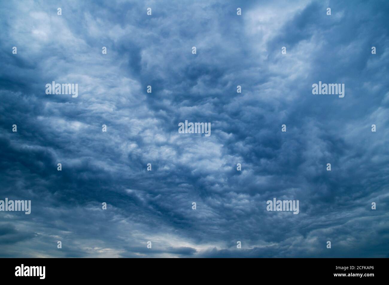 Dramatic dark blue sky with heavy clouds background Stock Photo - Alamy