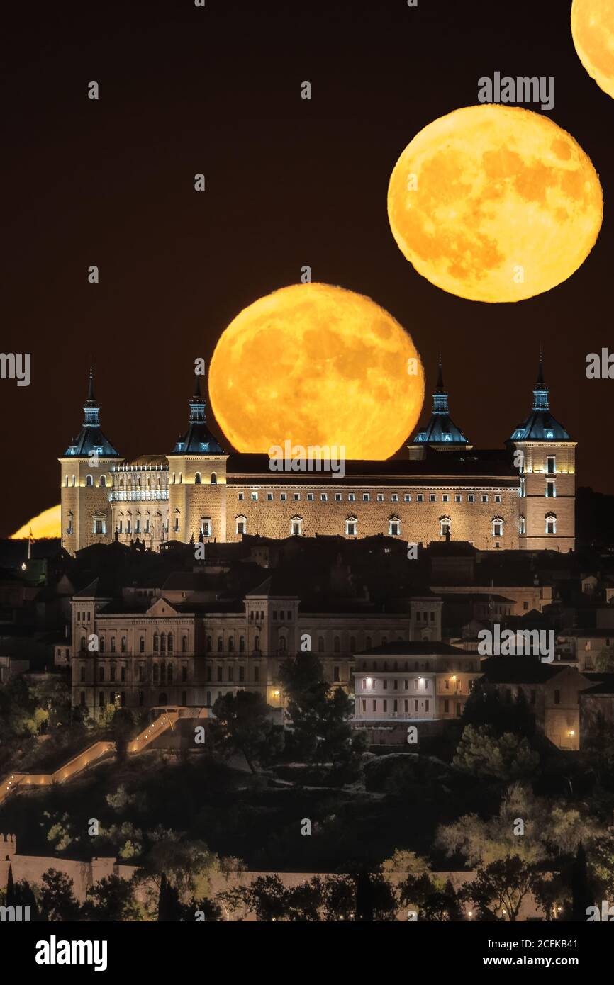 Amazing view of bright full moon in dark night sky over old town with ...