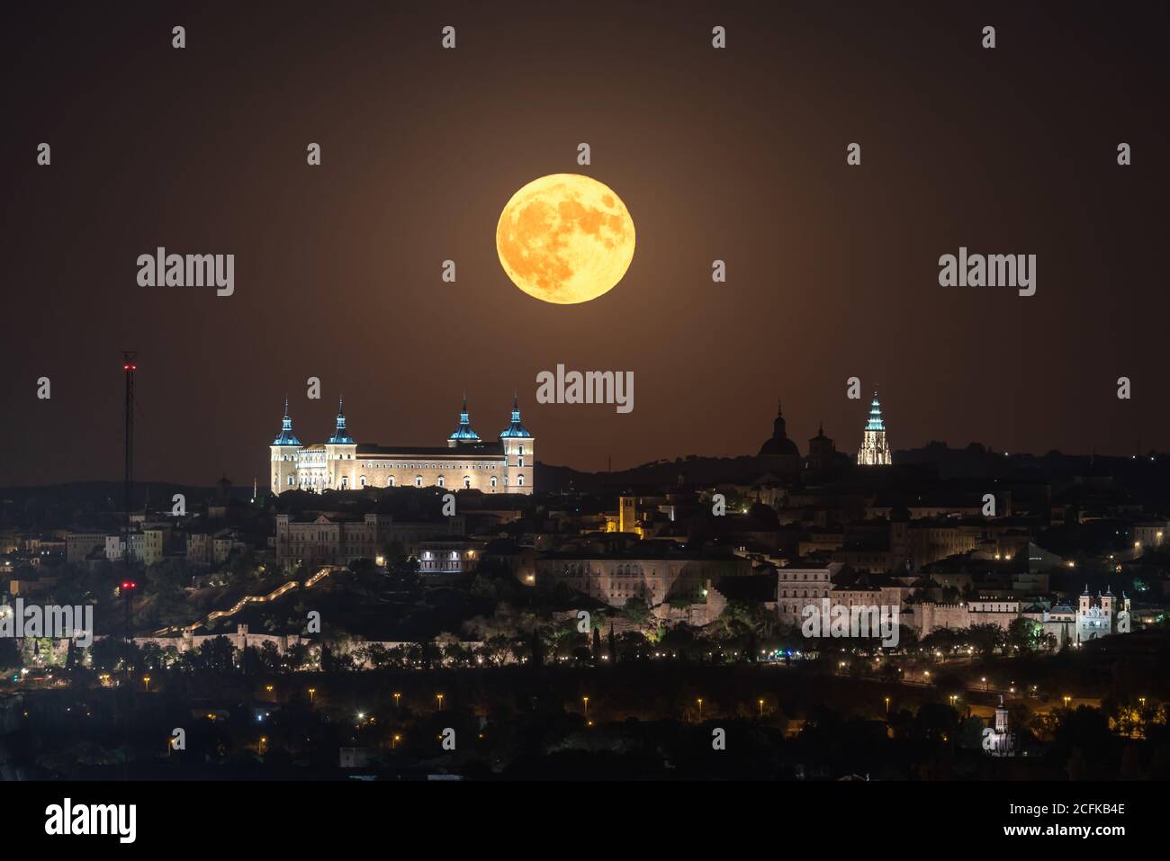 Amazing view of bright full moon in dark night sky over old town with ...