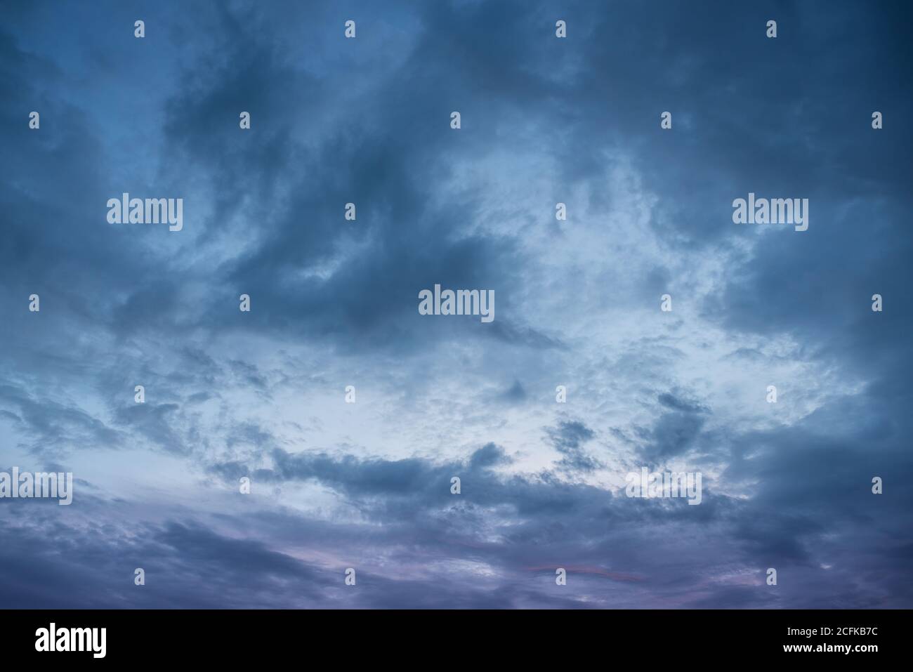 Dramatic dark blue sky with heavy clouds background Stock Photo - Alamy