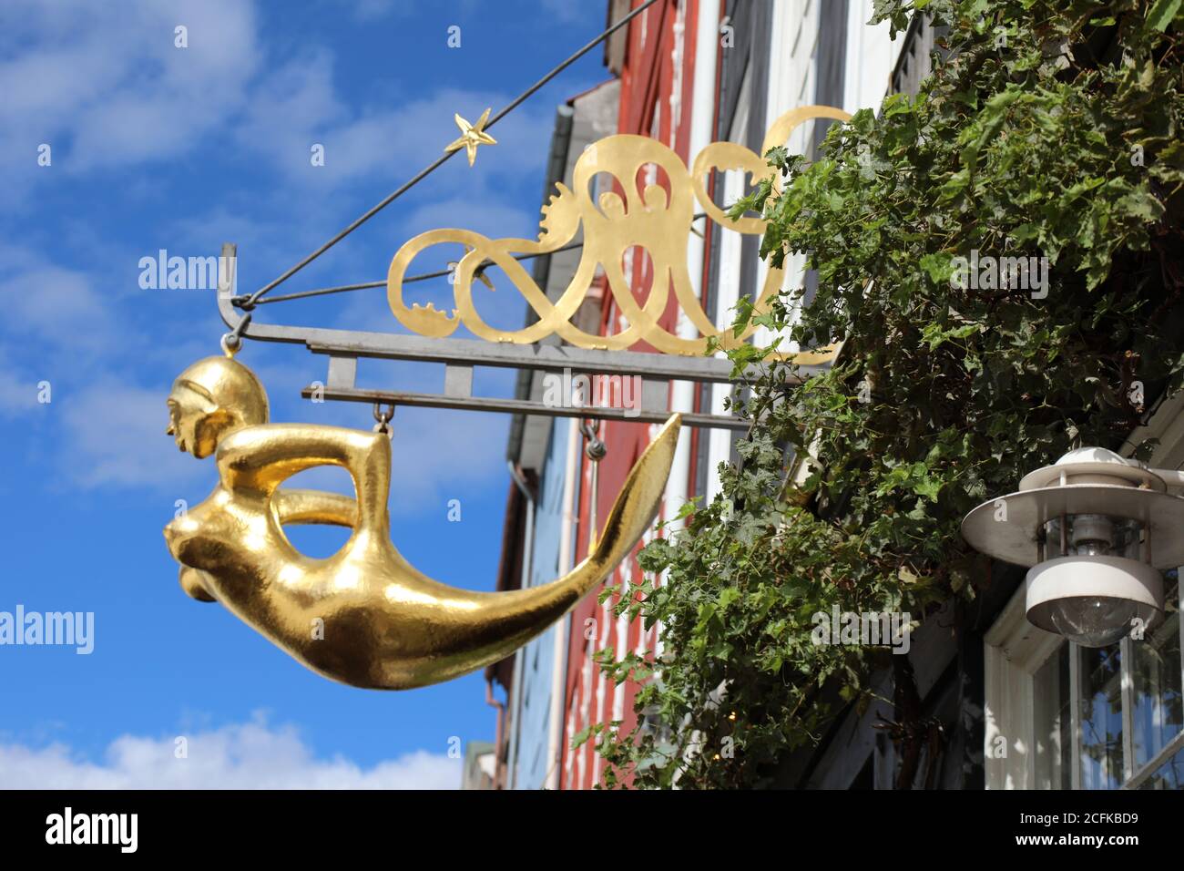 Gold mermaid restaurant sign at Nyhavn in wonderful Copenhagen Stock ...