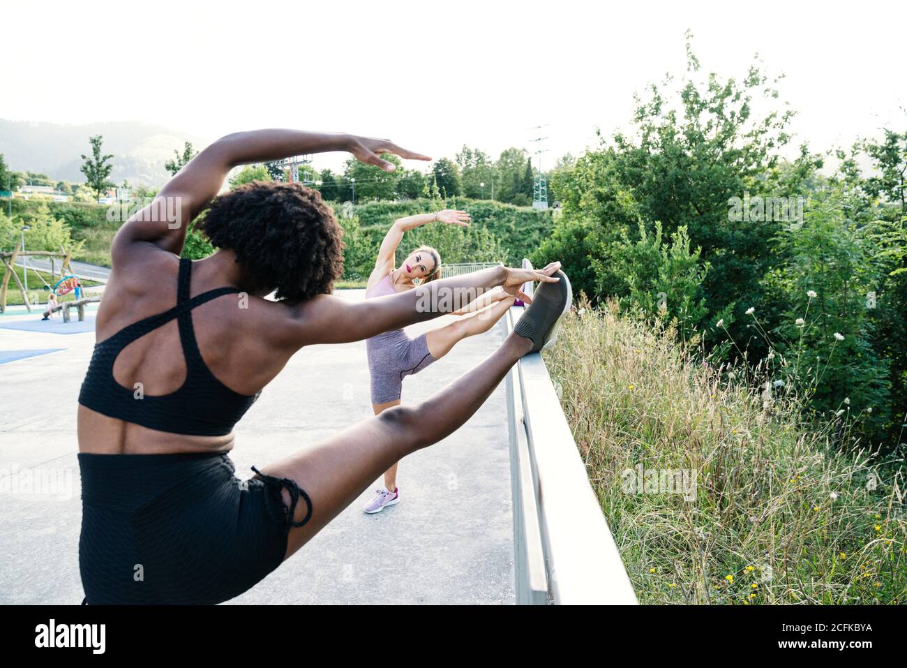 Full body of determined young multiethnic sportswomen doing squat ...