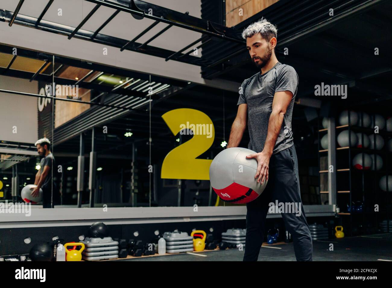 Full length of strong determined athletic male doing plank exercise ...