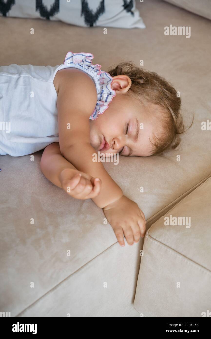 Little girl sleeping on the couch of a house Stock Photo - Alamy