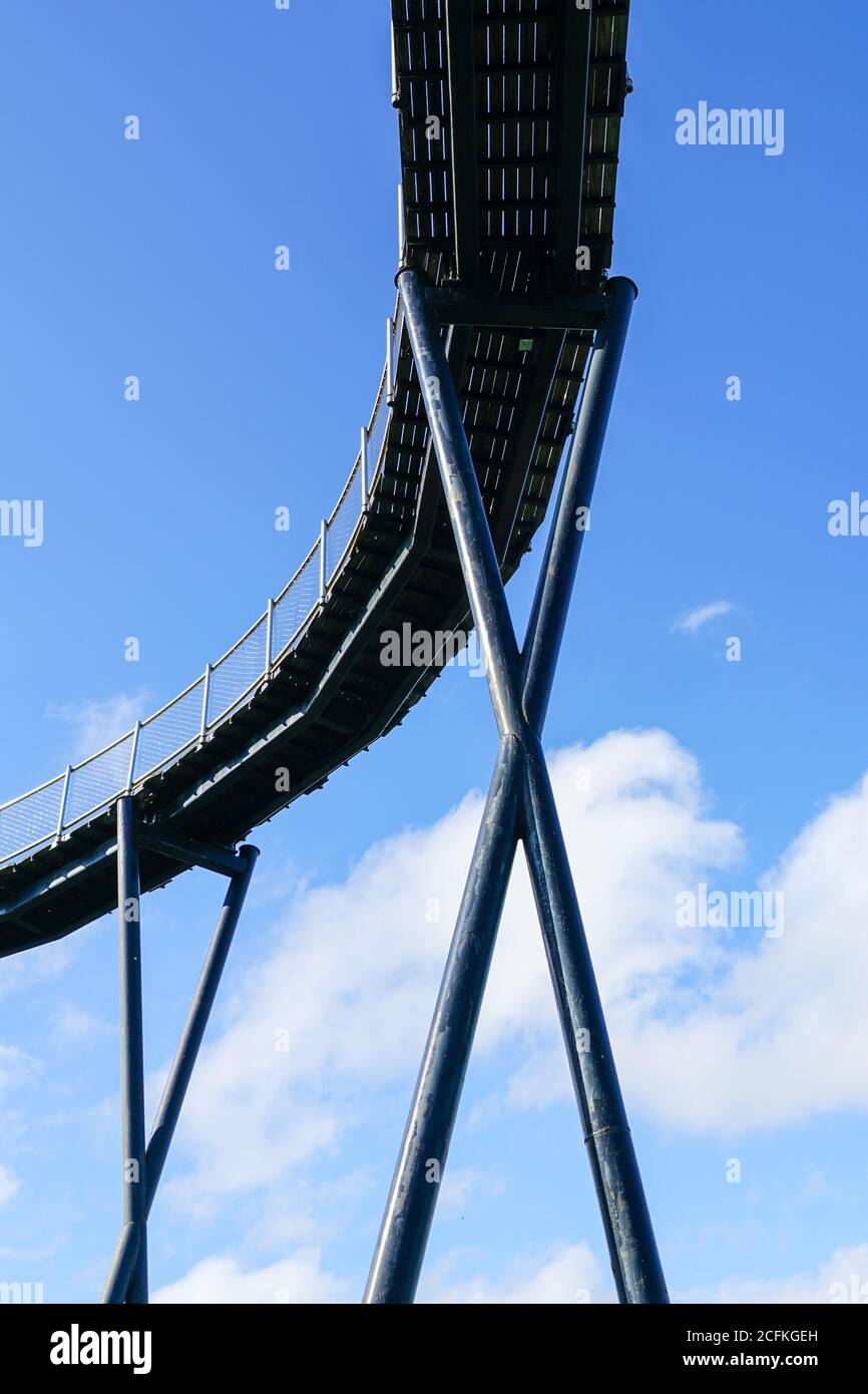 walking trail on high metal supports against a background of blue sky ...
