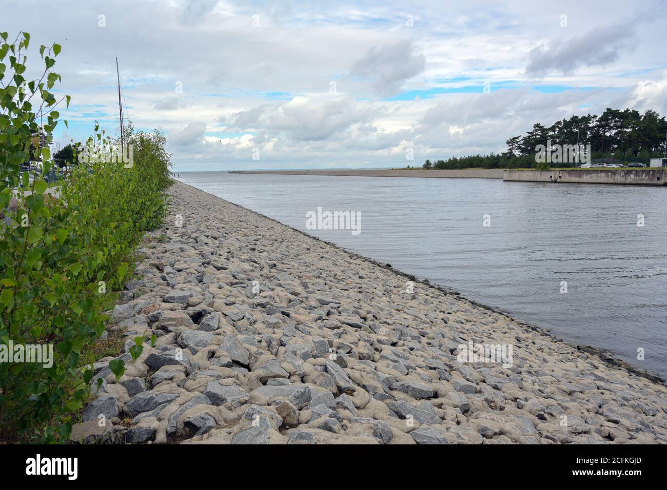 Industrial port Lubmin with fairway and quay under a cloudy sky, here ...