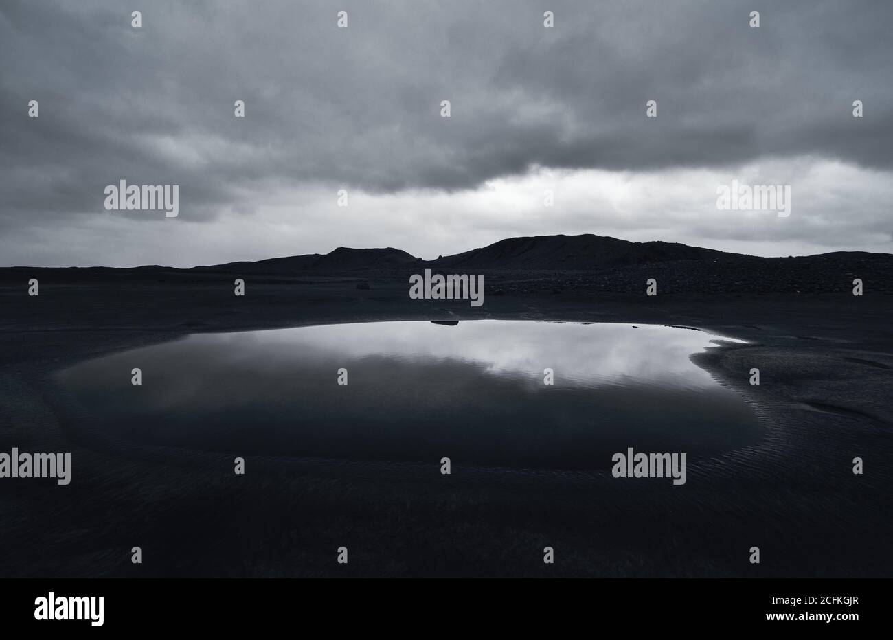 Dramatic stormy Icelandic landscape and reflection of retreated glacial ...