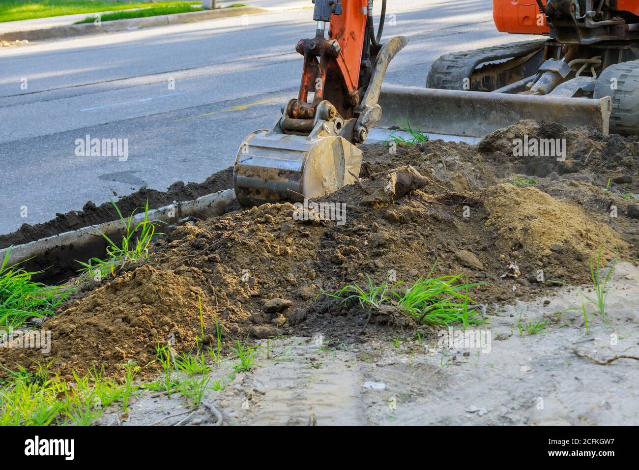 Backhoe on road work digger working at construction in excavation pit ...