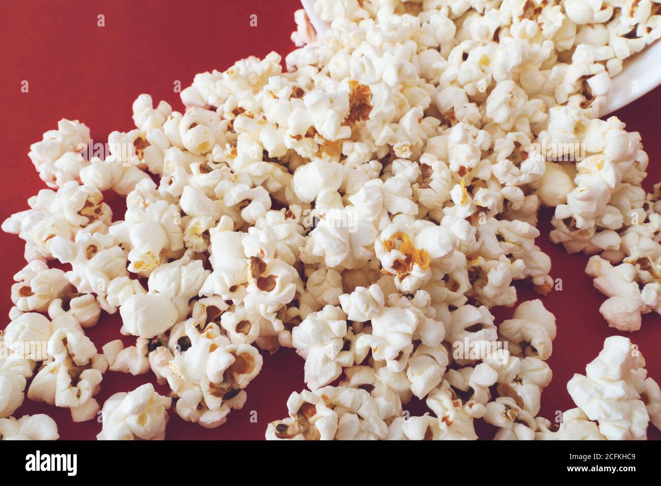 Spilled popcorn on a red background, cinema, movies and entertainment ...