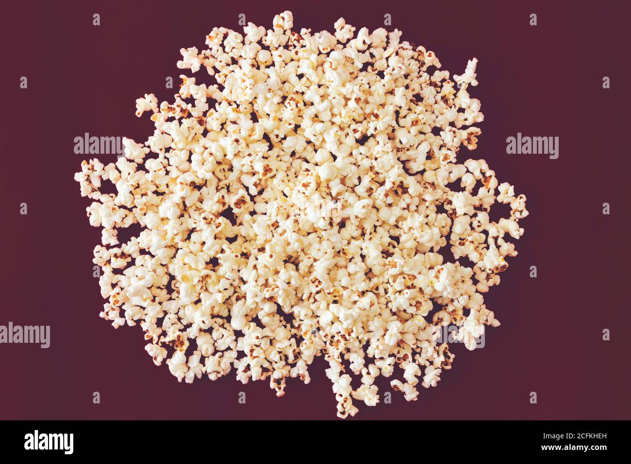 Spilled popcorn on a purple background, cinema, movies and ...