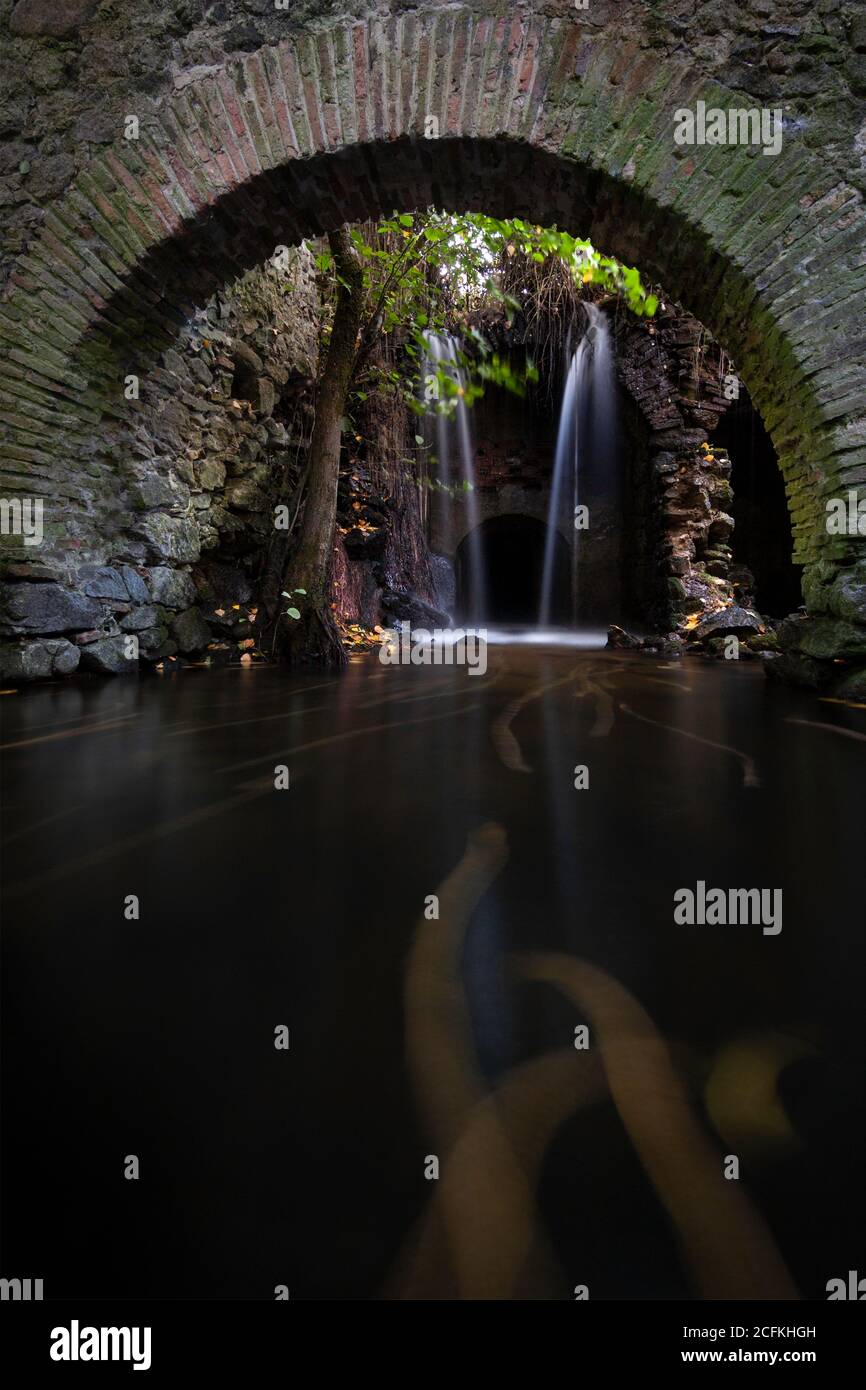 Waterfall in the ruins of an old mill. Nature scene, magical and ...